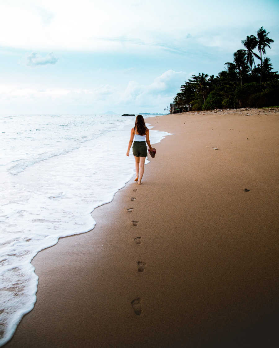tourist walking on beach in thailand - Travel Off Path