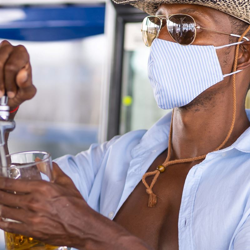 Bartender Serving Beer At The Beach - Travel Off Path