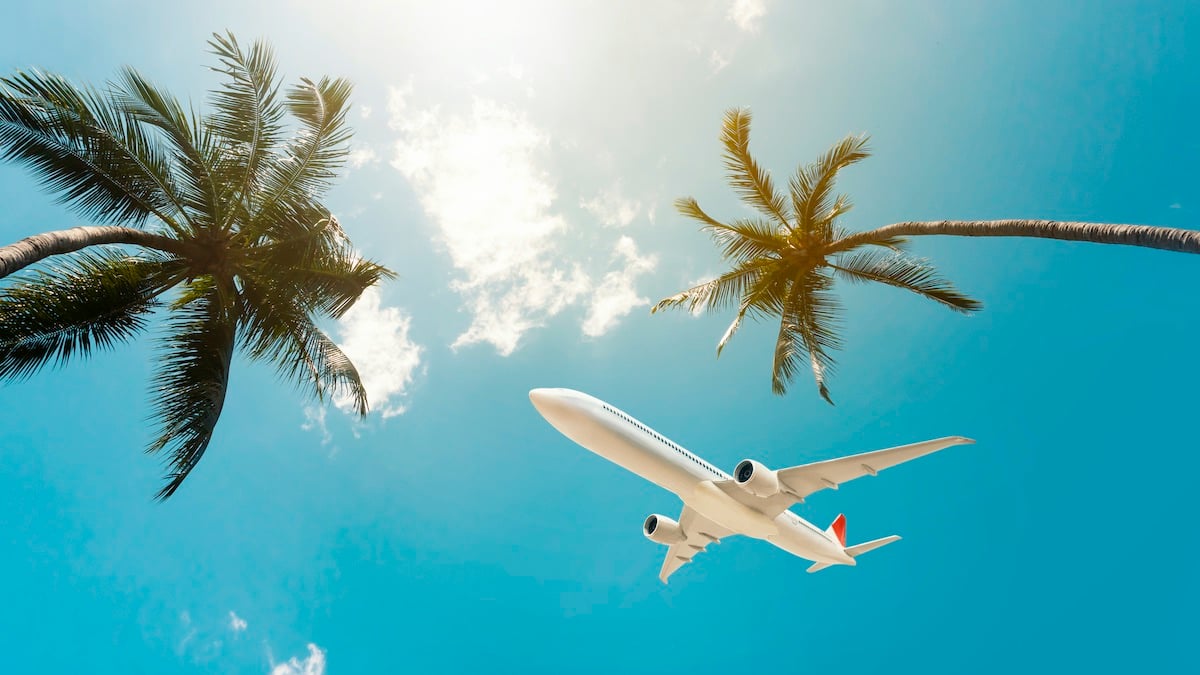 Airplane flying on tropical summer vacation. - Travel Off Path