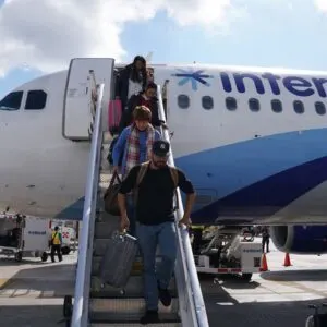 Passengers getting off of plane in cancun - Travel Off Path