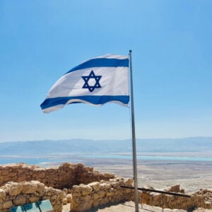Israeli Flag Flying Above Masada Fortress, Israel - Travel Off Path
