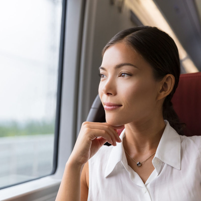 Woman looking outside window - Travel Off Path
