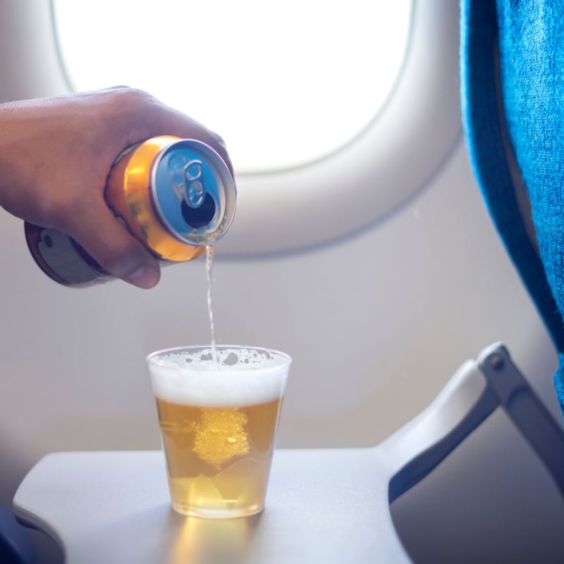 Pouring beer on airplane - Travel Off Path