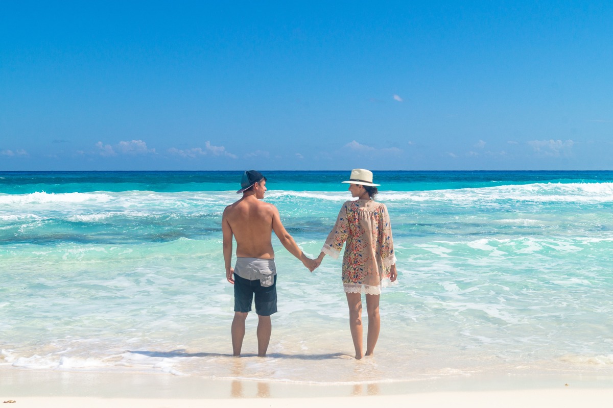 Young Couple Holding Hands At A Caribbean Beach, Unspecified Location ...