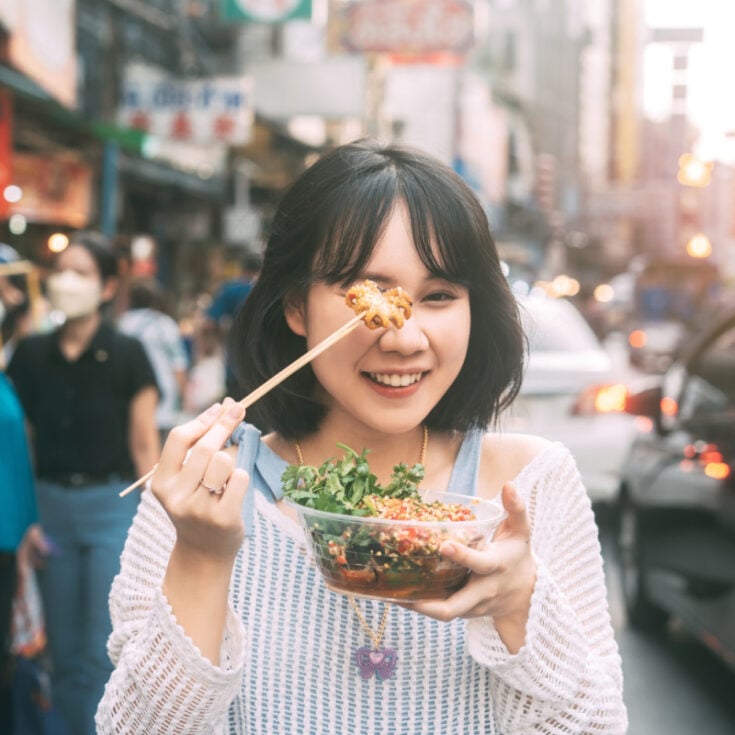 Woman Eating Street Food - Travel Off Path
