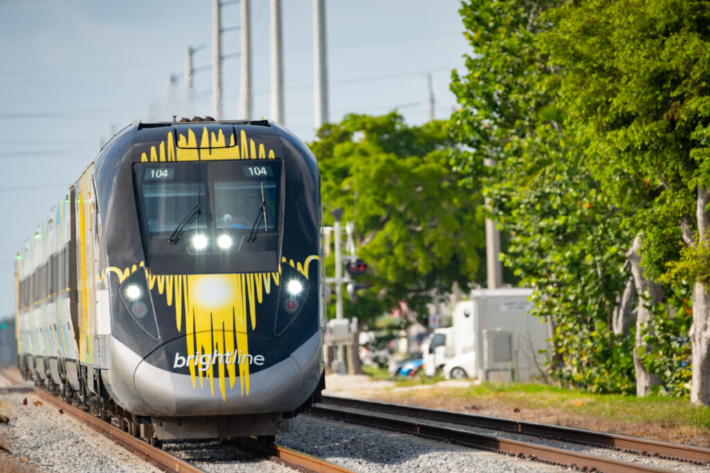 Telephoto shot of the Brightline train on tracks - Travel Off Path