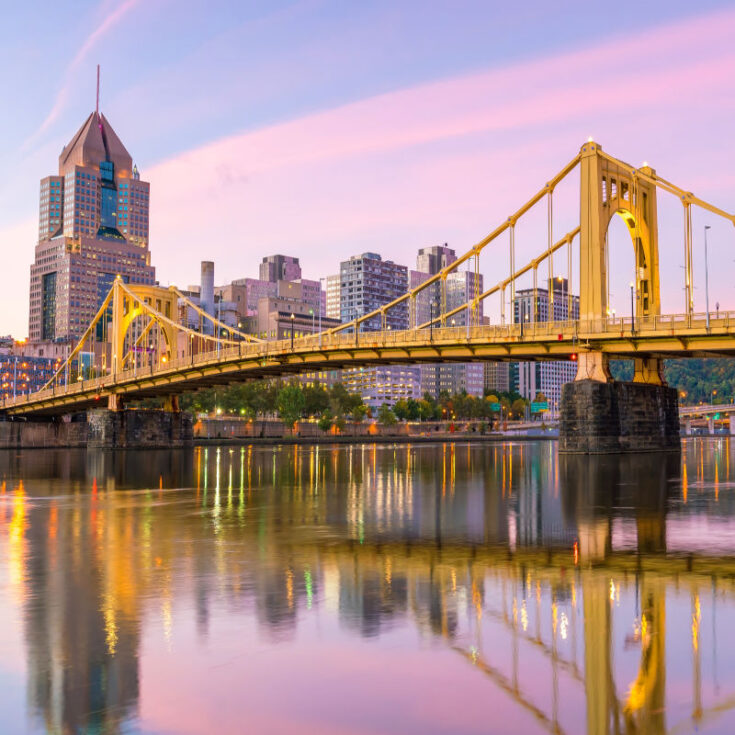 pittsburgh skyline at dusk with yellow bridge - Travel Off Path