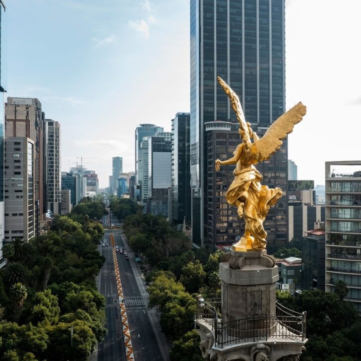 The Angel Statue In A Busy Avenue Lined By Skyscrapers In Mexico City ...