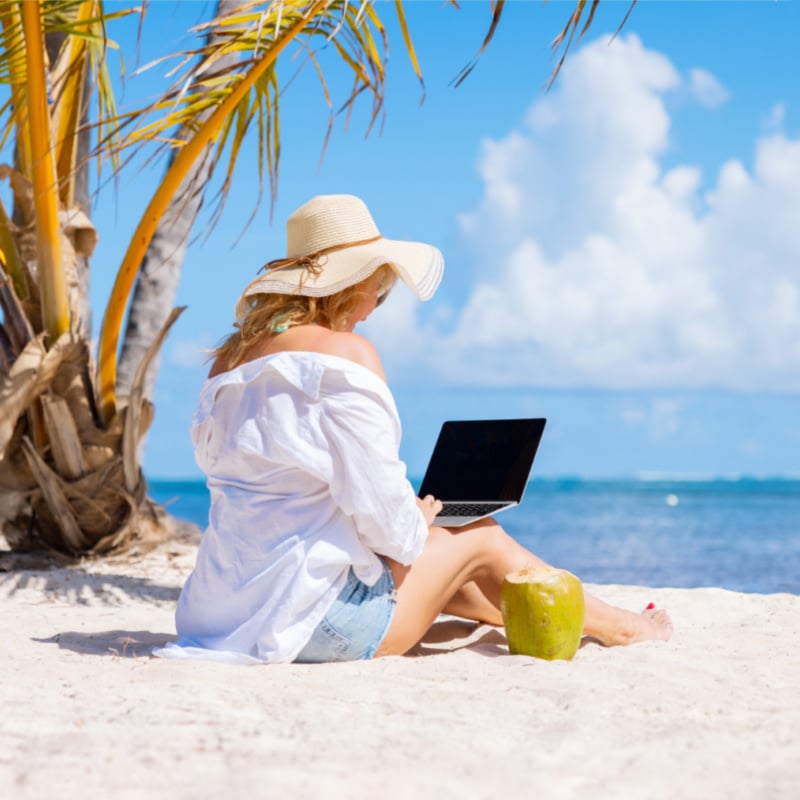Woman working with laptop computer on the tropical beach, concept of ...