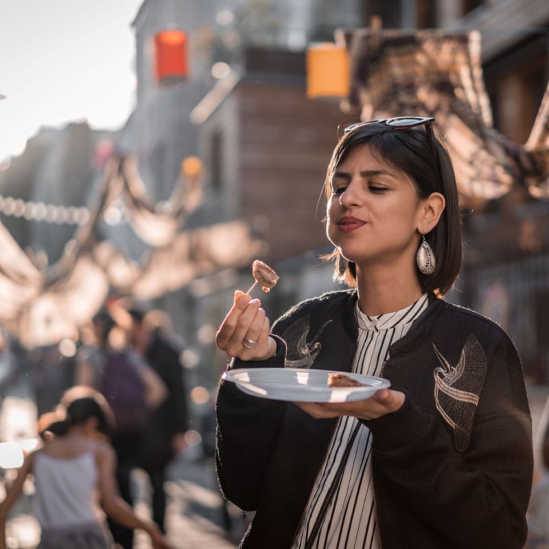 Beautiful young female tourist in city of Paris eating street food ...