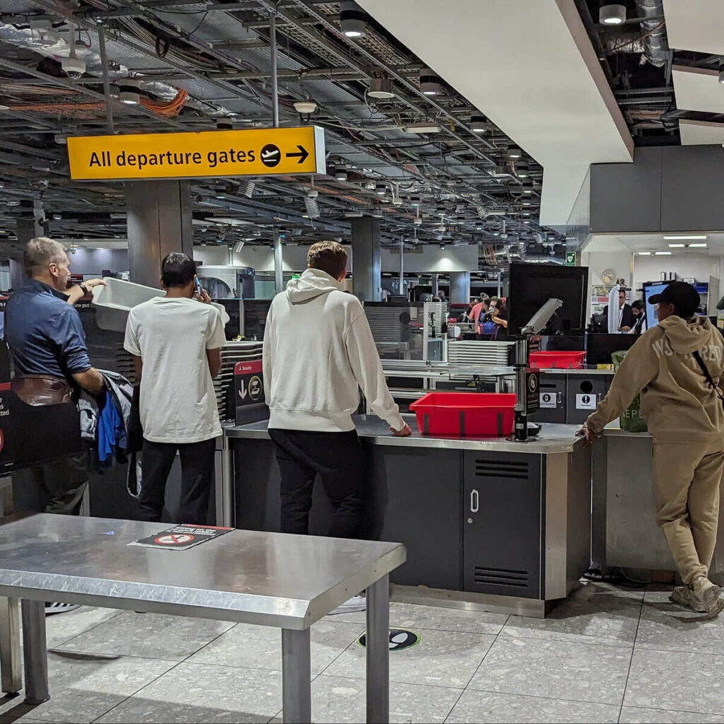 Passengers Passing Security Checks In London Heathrow, United Kingdom ...
